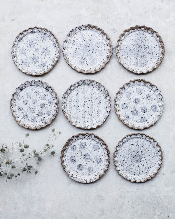 Gritty rustic cake plates with decorative patterns and sweet scalloped ...
